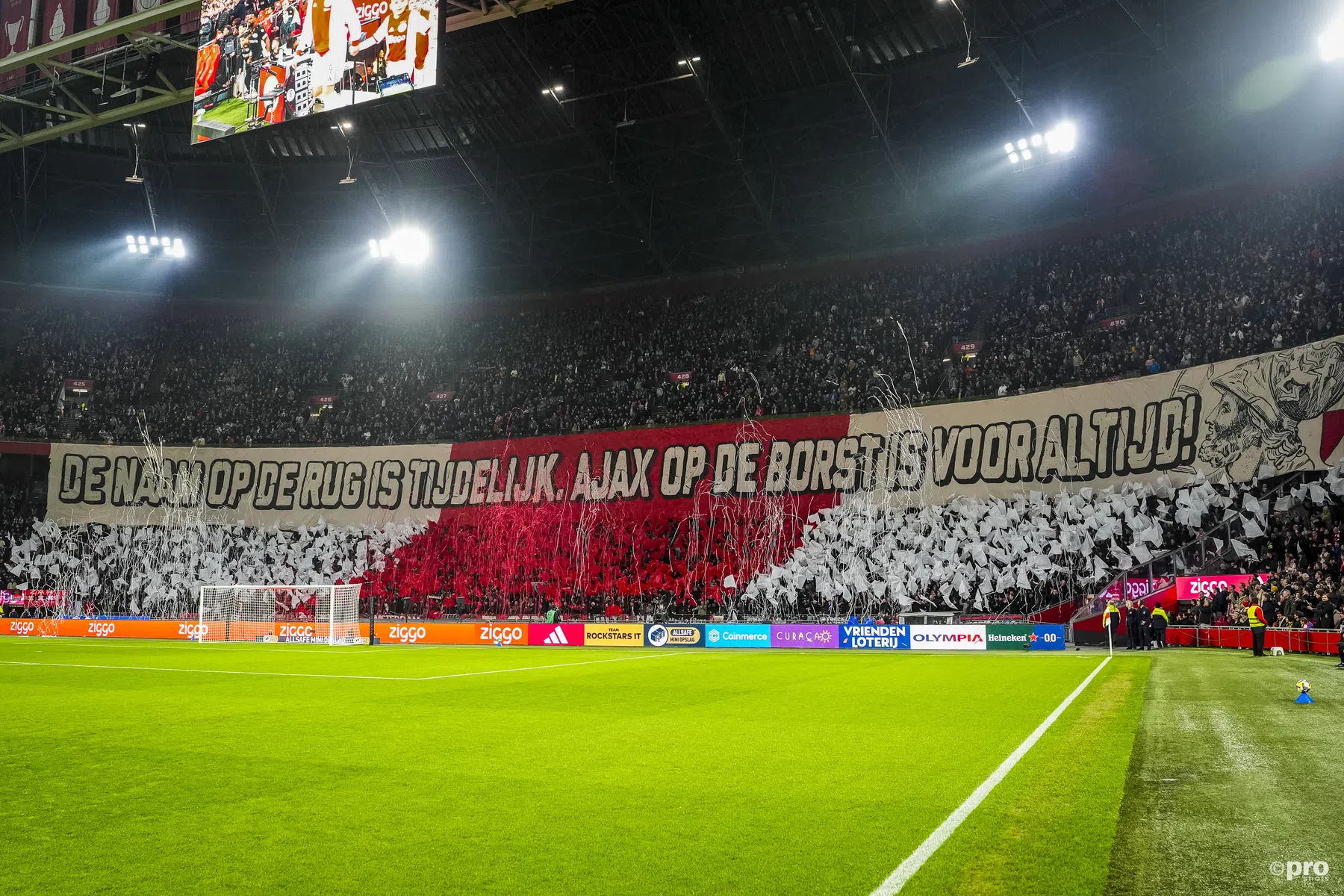 Fans van Ajax tonen spandoek tijdens duel met NEC in de Eredivisie